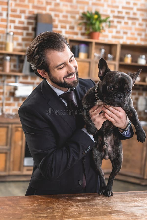 Smiling Loner Businessman Holding Dog Stock Photo - Image of ...