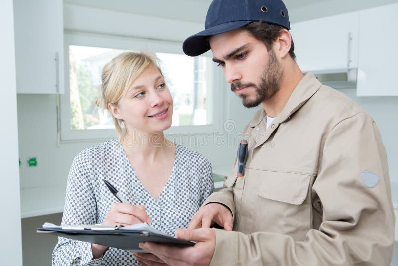 Smiling Maintenance Engineer with Female Customer Stock Image - Image ...
