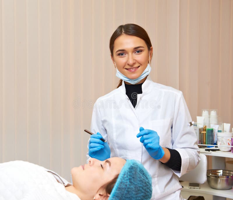 Smiling Make-up Master Makes Eyebrow Correction Procedure. Stock Photo ...