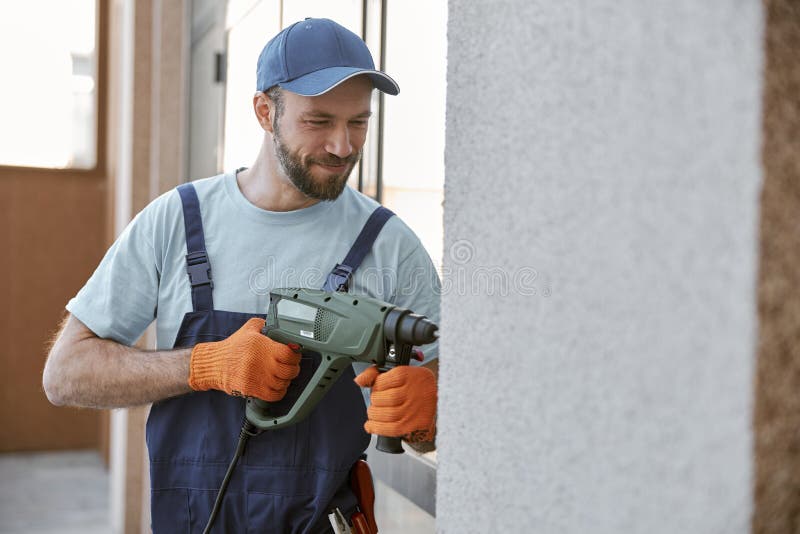 Bearded Young Man Drilling Wall with Hammer Drill Stock Image - Image ...
