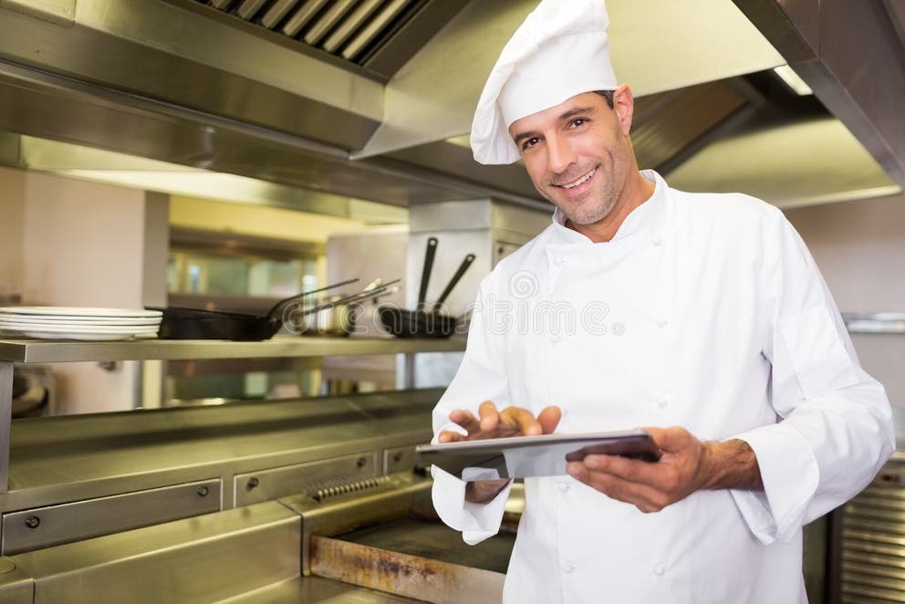 Smiling Male Cook Using Digital Tablet in Kitchen Stock Photo - Image ...