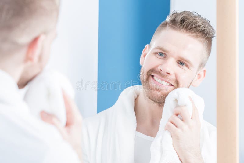 Smiling male drying face stock image. Image of attractive - 59529841