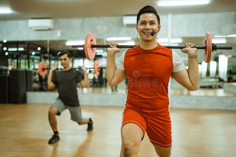 Smiling Male Instructor Doing Back Squats with Barbell Stock Image ...