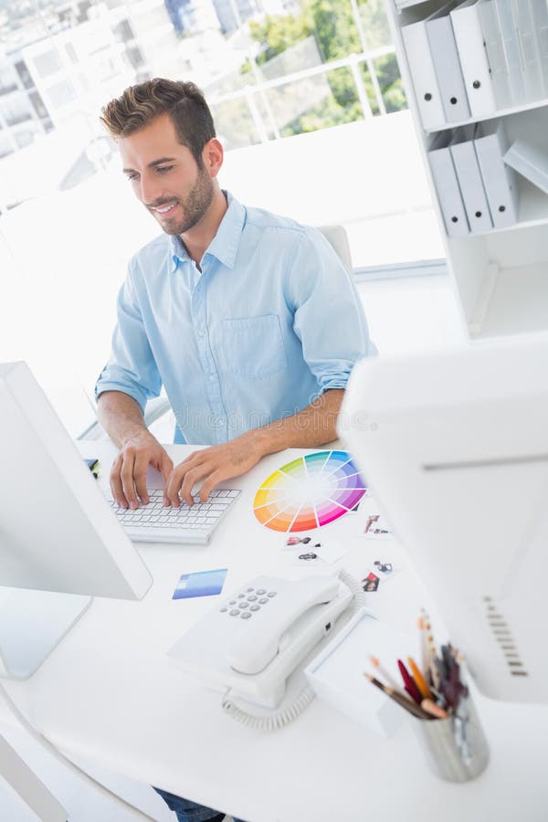 Smiling Male Photo Editor Using Computer Stock Photo - Image of table ...