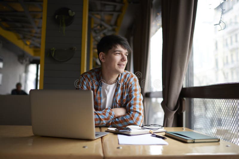 Smiling Male Student Sitting Front Open Laptop Computer while Looking ...