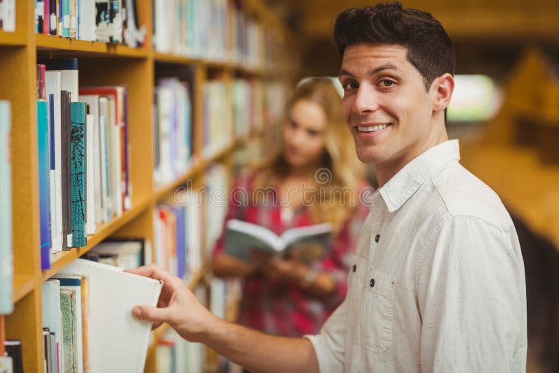 Boy Taking a Book from Bookshelf in Library Stock Photo - Image of ...