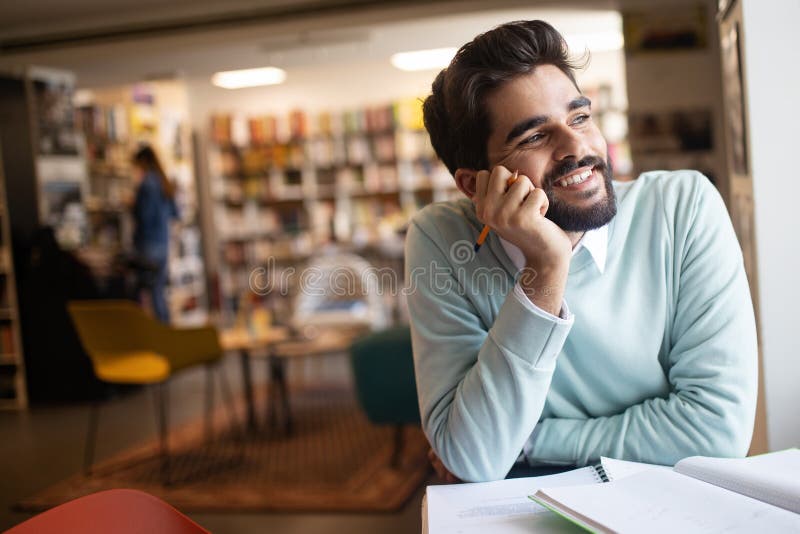 Smiling Male Student Working and Learning in a Library Stock Photo ...