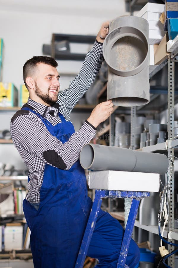 Smiling Male Worker Choosing Drain Pipe Detail Stock Image - Image of ...