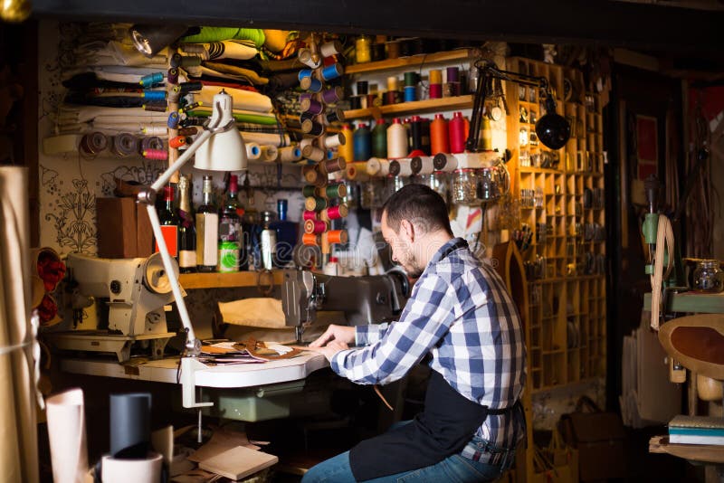 Smiling Male Worker Working on Stitches for Belt Stock Image - Image of ...