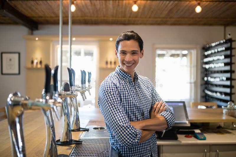 Smiling Man with Arms Crossed at Counter in Restaurant Stock Image ...