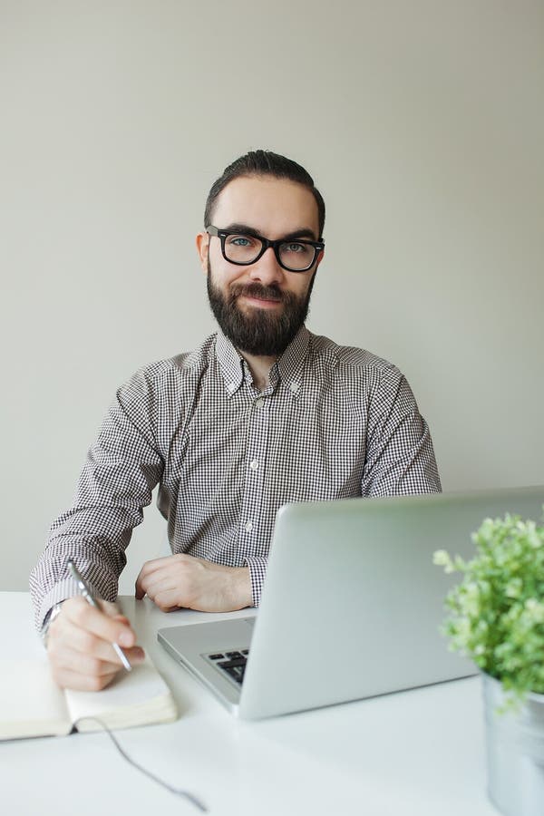 Smiling Man with Beard in Glasses Taking Notes with Laptop Notepad ...