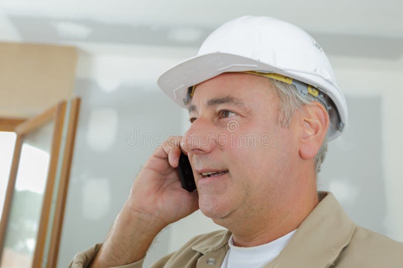 Smiling Man Builder in Hard Hat Using Mobile Phone Stock Photo - Image ...