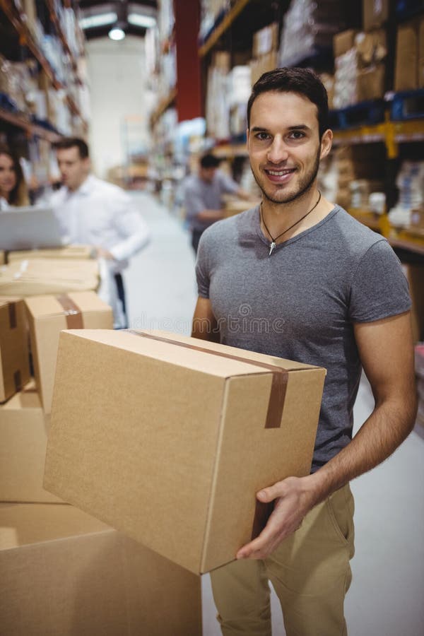 Smiling man carrying box stock image. Image of four, businessman - 66935927