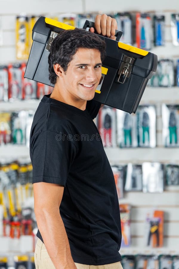 Man Carrying Toolbox on Shoulder in Hardware Store Stock Photo - Image ...