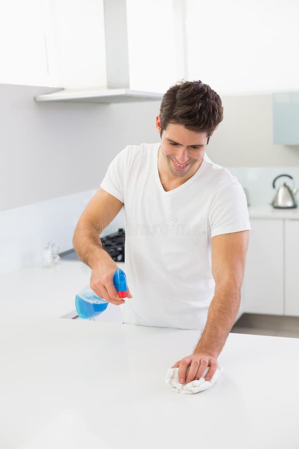 Smiling Man Cleaning Kitchen Counter in House Stock Photo - Image of ...