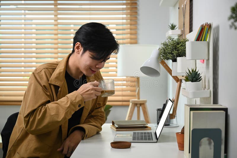 Man Drinking Coffee and Using Laptop Computer. Stock Photo - Image of ...