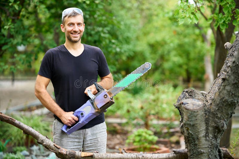 Smiling Man with Electric Chainsaw Posing in His Garden Stock Image ...