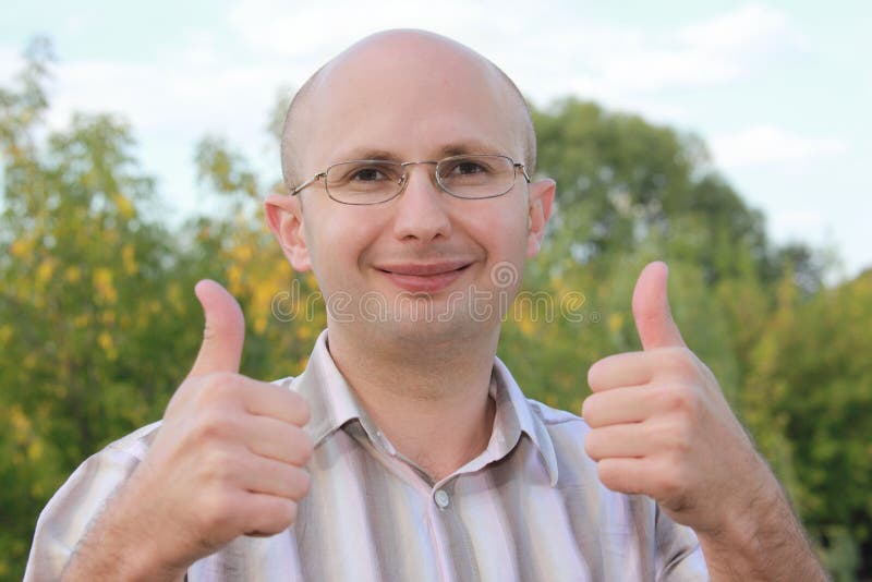 Smiling Man in Fall Park with Thumbs Up Gestures Stock Image - Image of ...