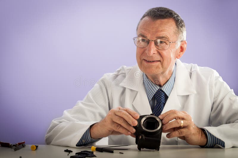 Smiling Man Fixing Camera stock image. Image of electrician - 28125073