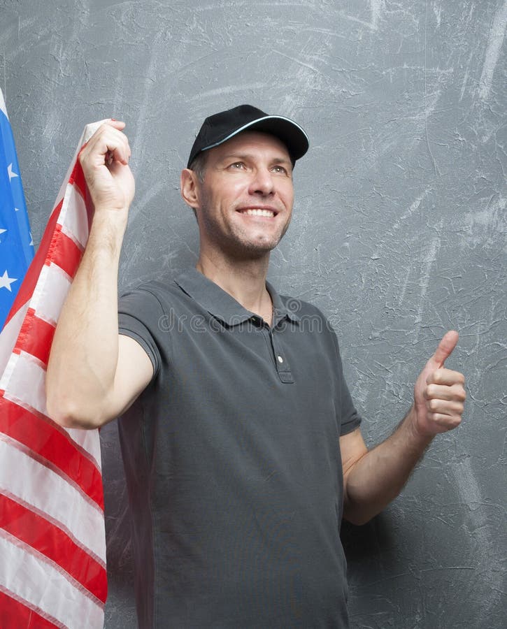 Smiling Man in Gray Against Background of USA Flag Stock Image - Image ...