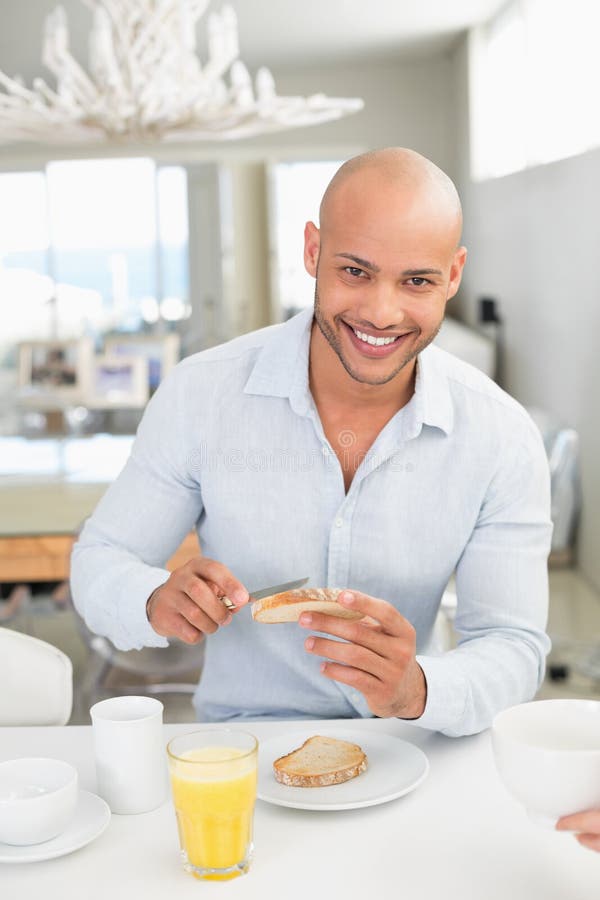 Smiling Man Having Breakfast at Home Stock Photo - Image of mixedrace ...