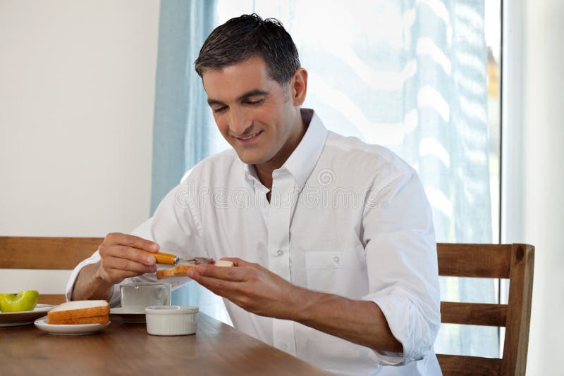 Smiling Man Having Breakfast Stock Photo - Image of healthy, holding ...