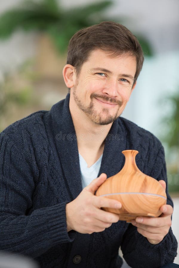 Smiling Man Holding Diffuser for Essential Oils Stock Photo - Image of ...
