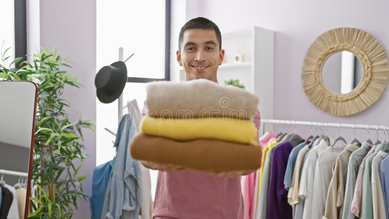 Smiling Man Holding Folded Laundry in a Modern, Well-organized Dressing ...