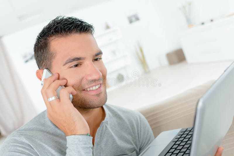 Smiling Man Holding Laptop and Talking on Telephone Stock Image - Image ...