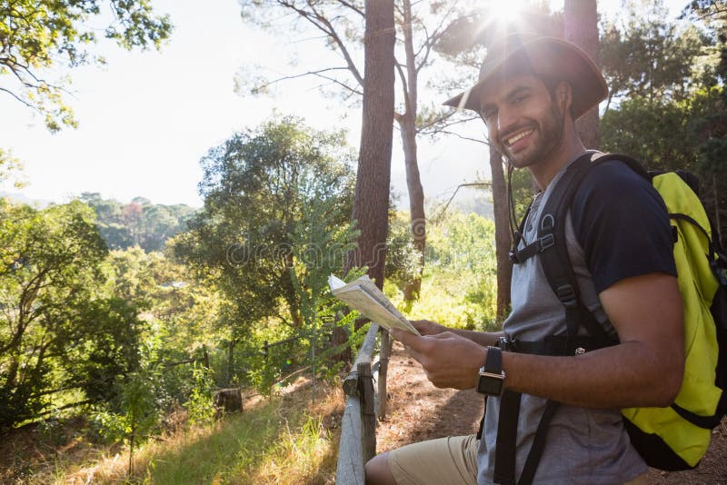 Smiling Man Holding the Map and Standing Near the Fence Stock Image ...