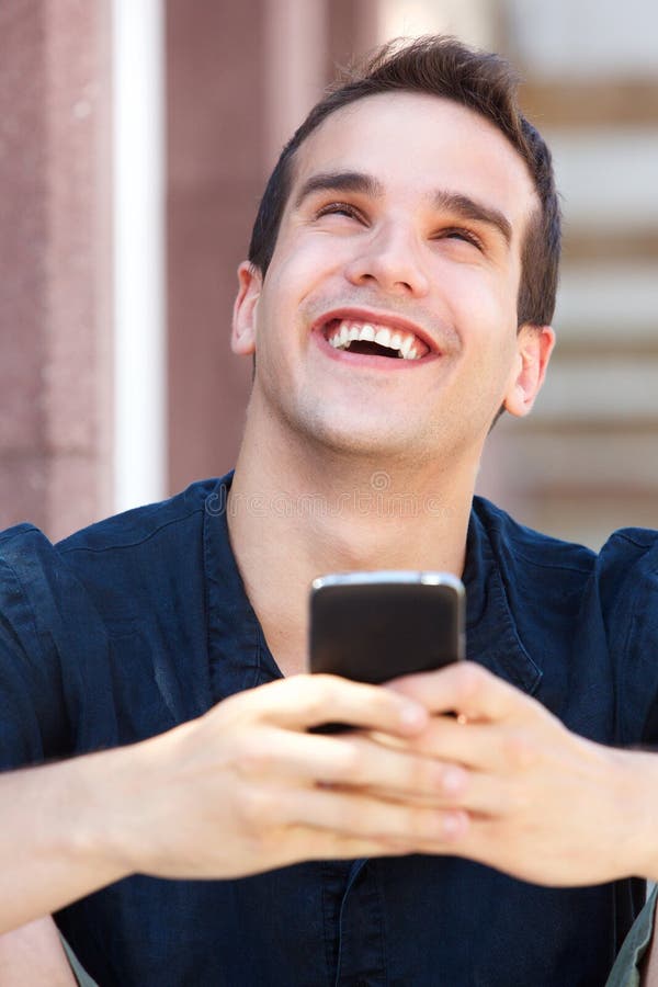 Smiling Man Holding Mobile Phone and Looking Up Stock Photo - Image of ...