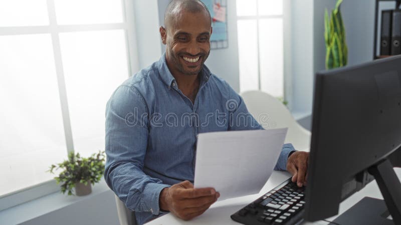 Smiling Man Holding Paper in Modern Office, Working at Computer ...