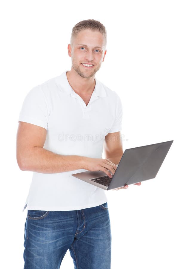 Smiling Man in Jeans Using a Laptop Computer Stock Image - Image of ...