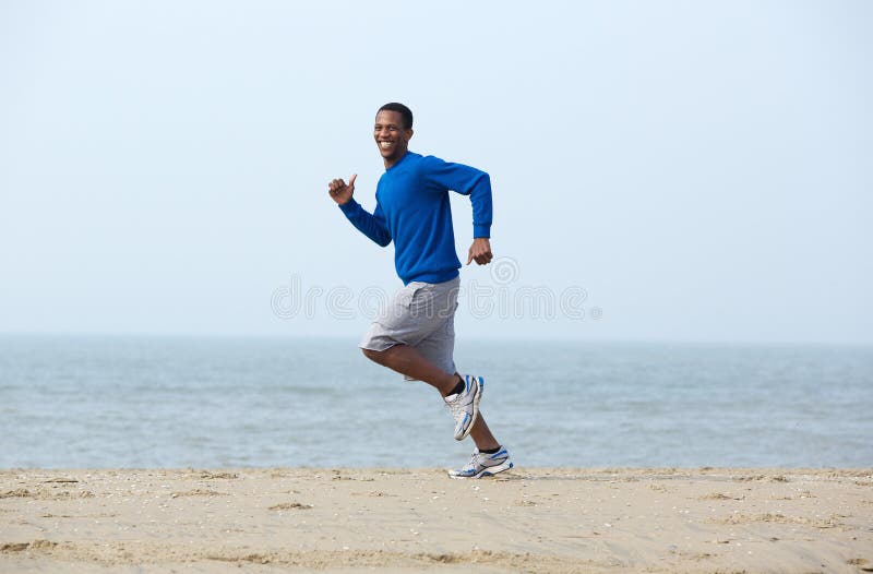 Smiling Man Jogging at the Beach Stock Photo - Image of lifestyle ...