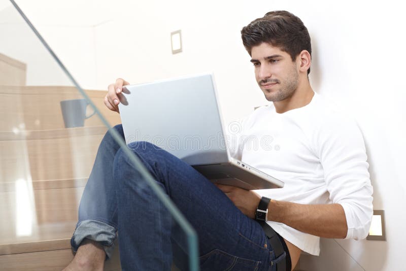 Smiling Man with Laptop Computer at Home Stock Image - Image of casual ...