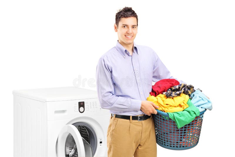 A Smiling Man with Laundry Bin Posing Next To a Washing Machine Stock ...