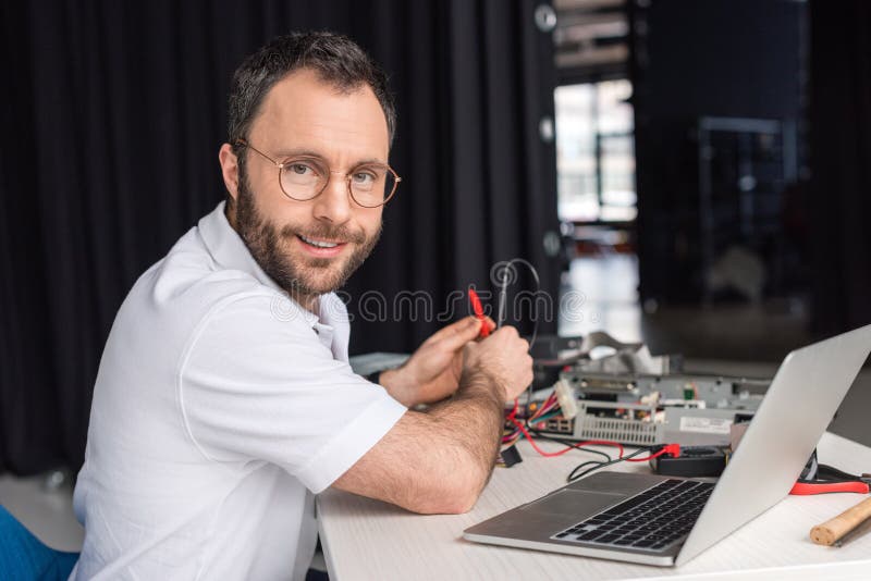Smiling Man Looking at Camera while Holding Multimeter Stock Photo ...