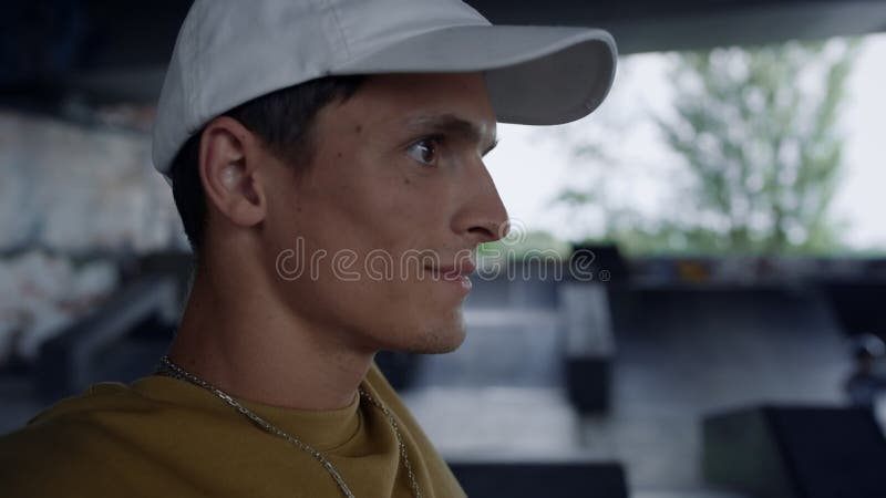 Smiling Man Looking Training at Skatepark. Side View Guy Looking ...