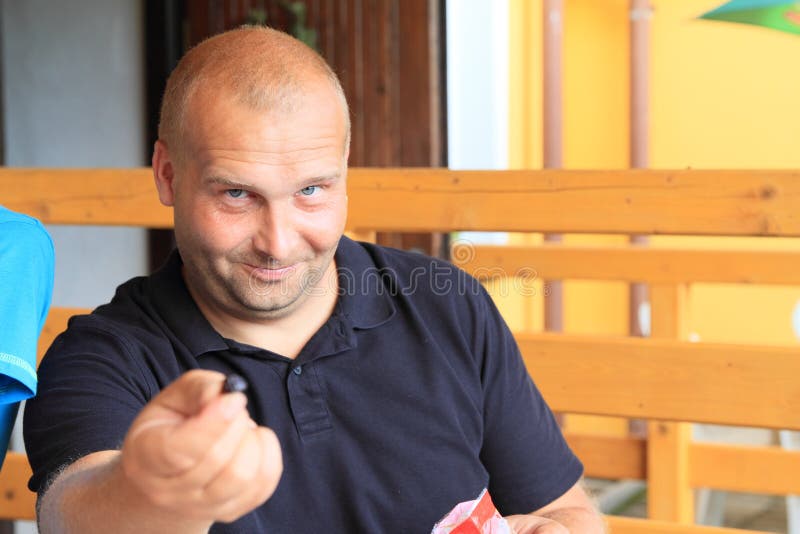 Smiling man offering candy stock image. Image of sweetmeat - 43182305