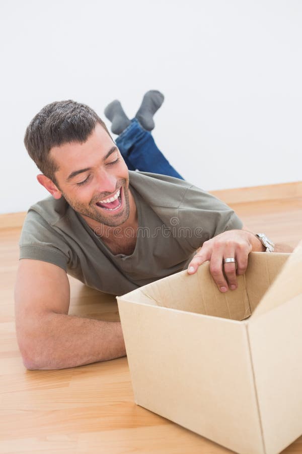Smiling Man Open a Moving Box at Home Stock Image - Image of household ...