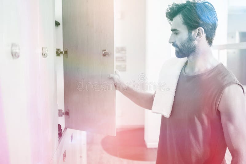 Smiling man opening locker stock image. Image of care - 84441777