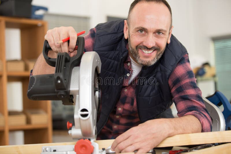 Smiling Man Operating Circular Saw in Wood Workshop Stock Photo - Image ...