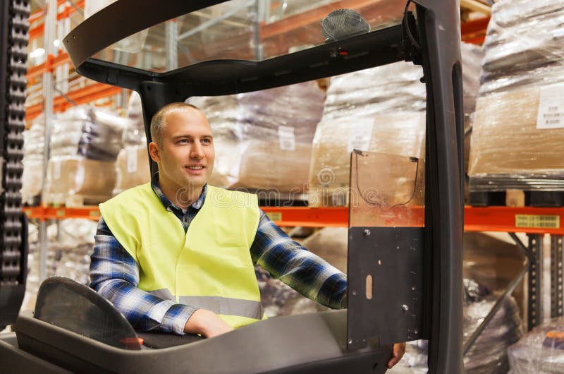 Smiling Man Operating Forklift Loader at Warehouse Stock Photo - Image ...