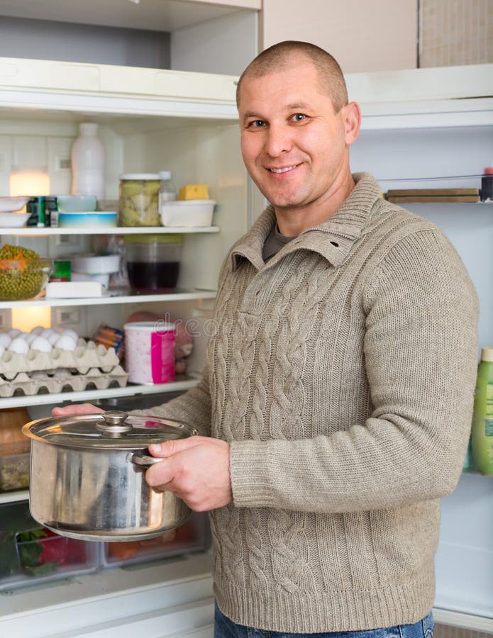 Smiling Man with Pan Near Fridge Stock Image - Image of food, look ...