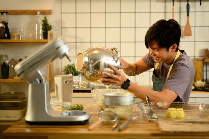 Smiling Man Pouring Creamy Mixture from Bowl during the Preparation of ...