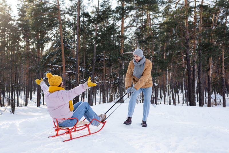 Smiling Man Pulling Girlfriend on Sled Stock Image - Image of park ...