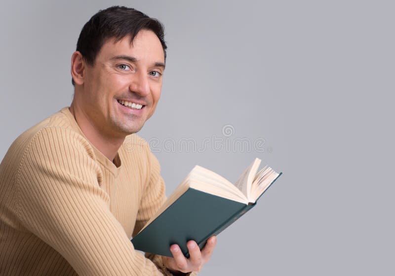 Smiling man reading a book stock image. Image of satisfied - 53746137