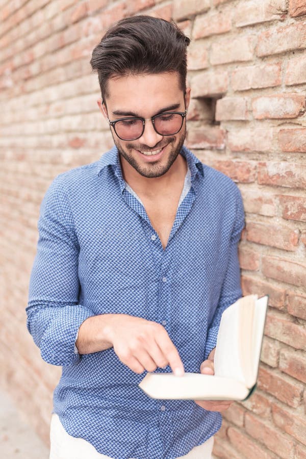 Smiling Man Reading a Book and Points To it Stock Image - Image of ...