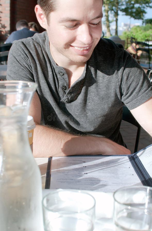 Smiling Man Reading Menu in Restaurant Stock Photo - Image of european ...