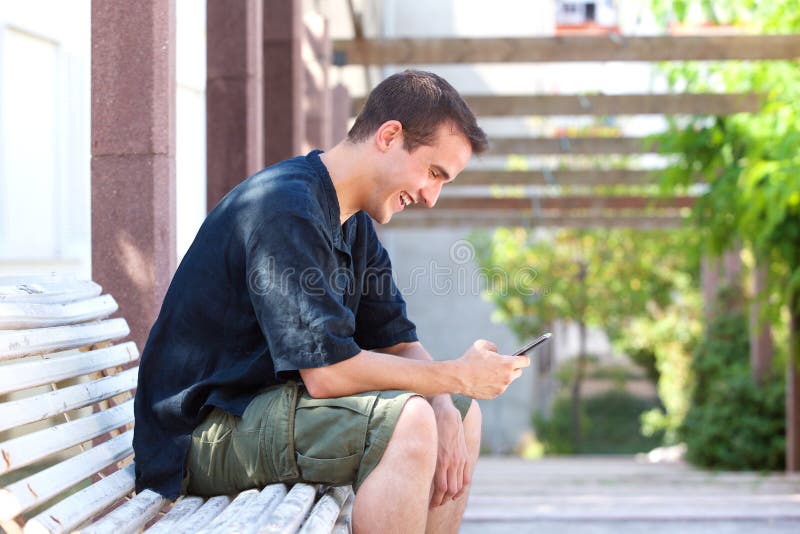 Smiling Man Reading Text Message on Cell Phone Stock Photo - Image of ...